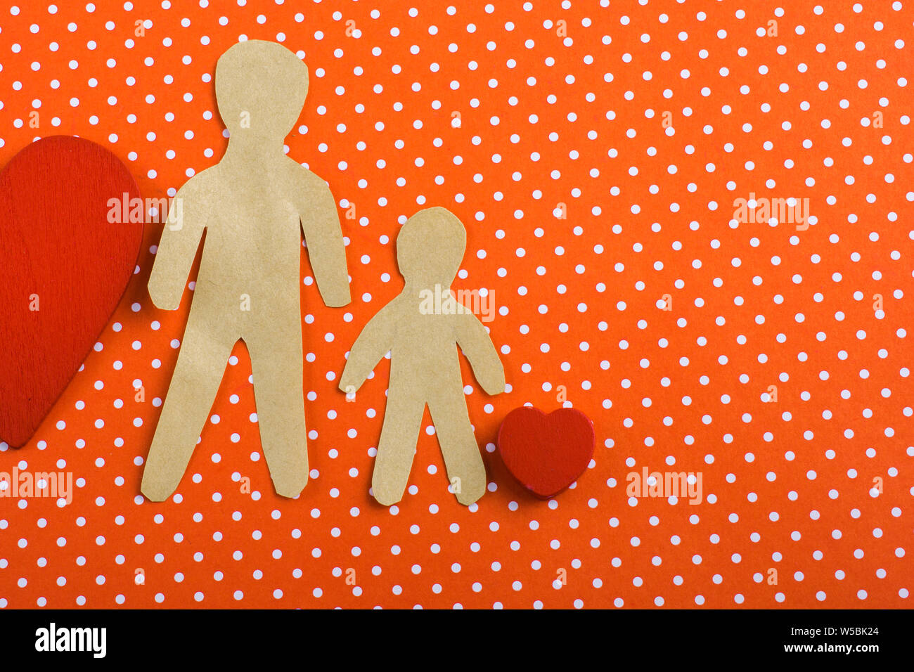Man and child shape cut out of paper in the view Stock Photo - Alamy