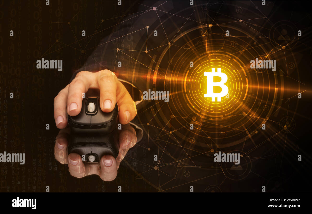Hand using wireless mouse with cryptocurrency concept on dark ...
