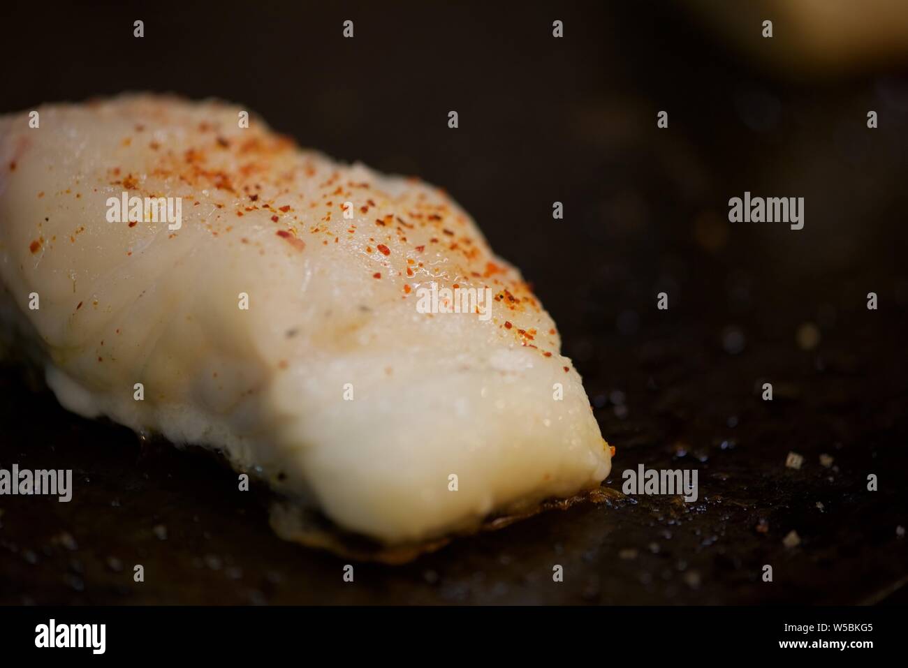 Cooking Fish: pieces of Cod fillet cooking on a hot plate in a ...