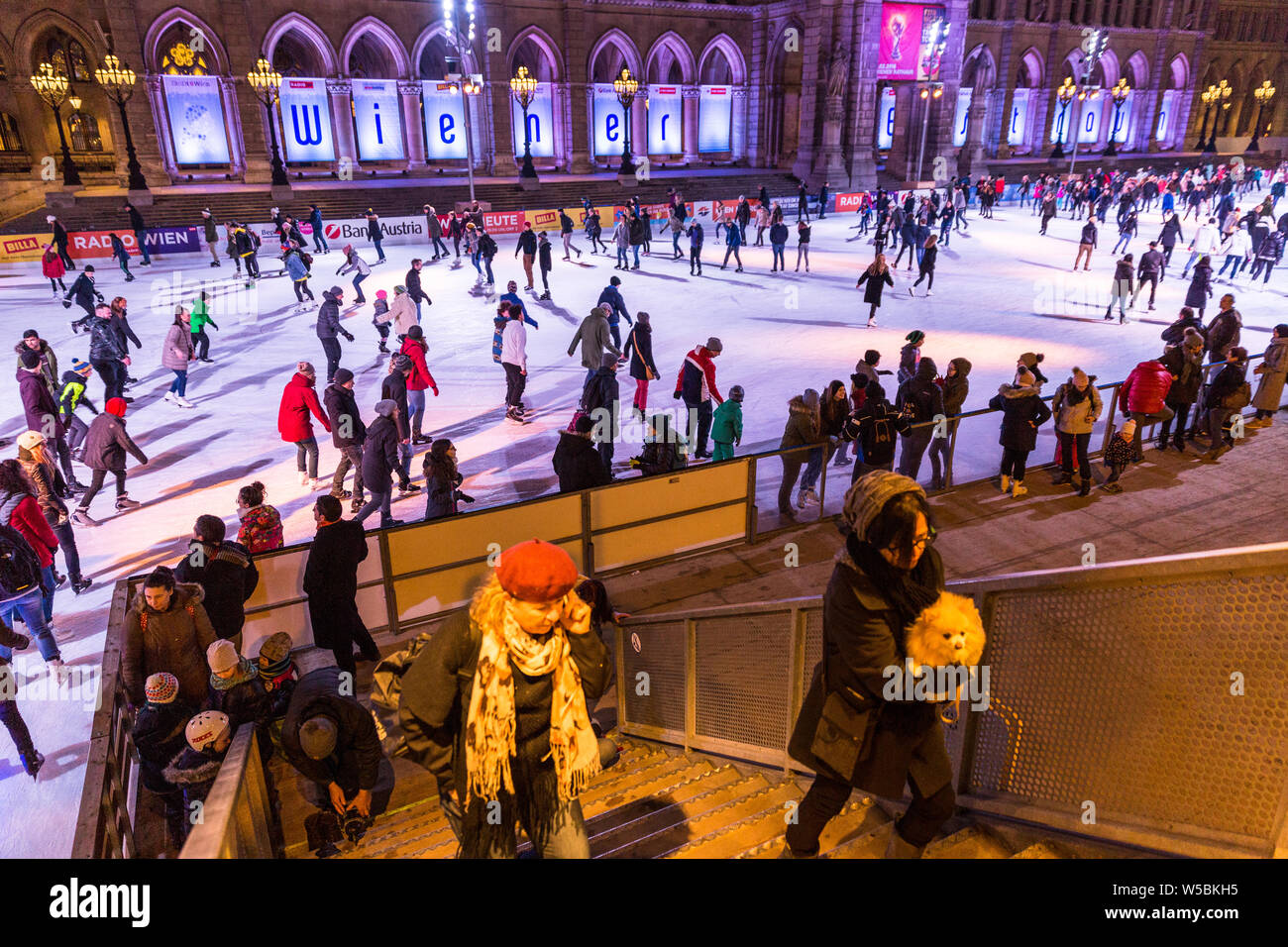 Crowd of people skating in front of Rathausplatz which is transformed ...
