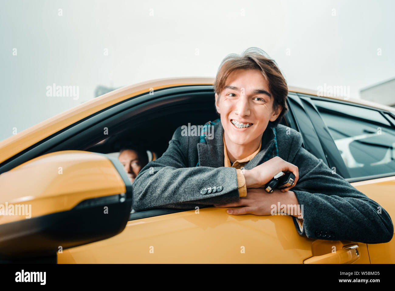Happy young man looking out of the car window Stock Photo - Alamy
