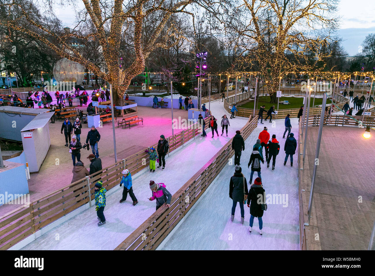 Crowd of people skating in front of Rathausplatz which is transformed ...
