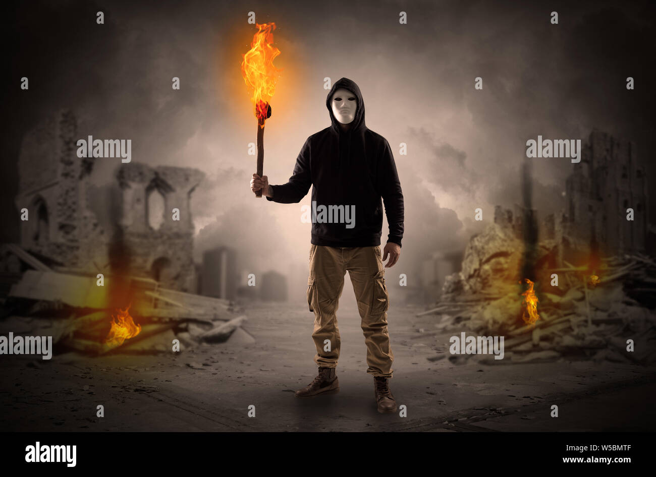 Destroyed place after a catastrophe with man and burning flambeau ...
