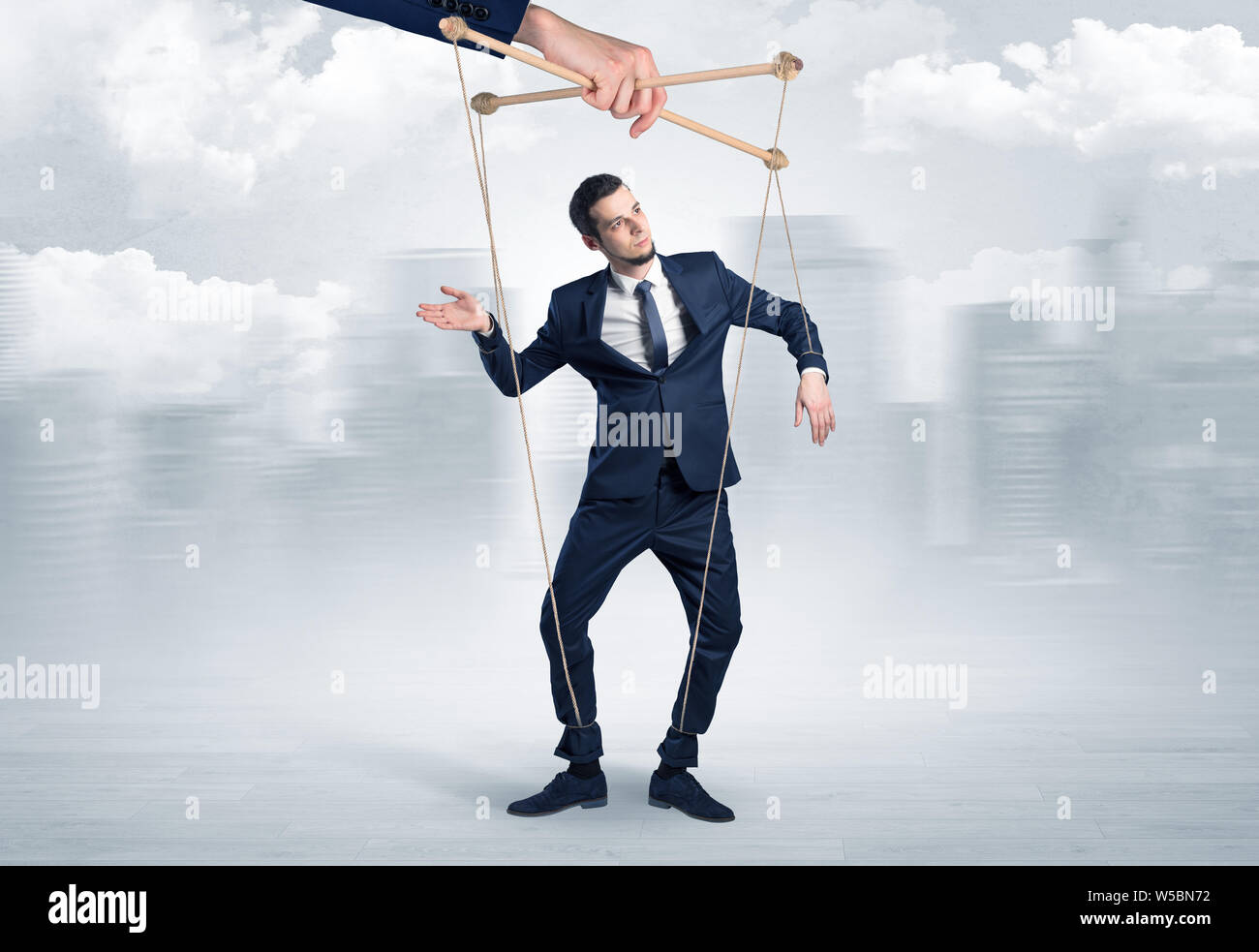 Puppet man with big city great power concept Stock Photo - Alamy