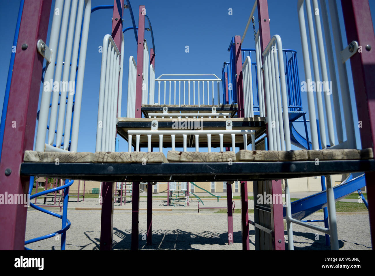 Playground wood climbing area in school yard with school in background ...