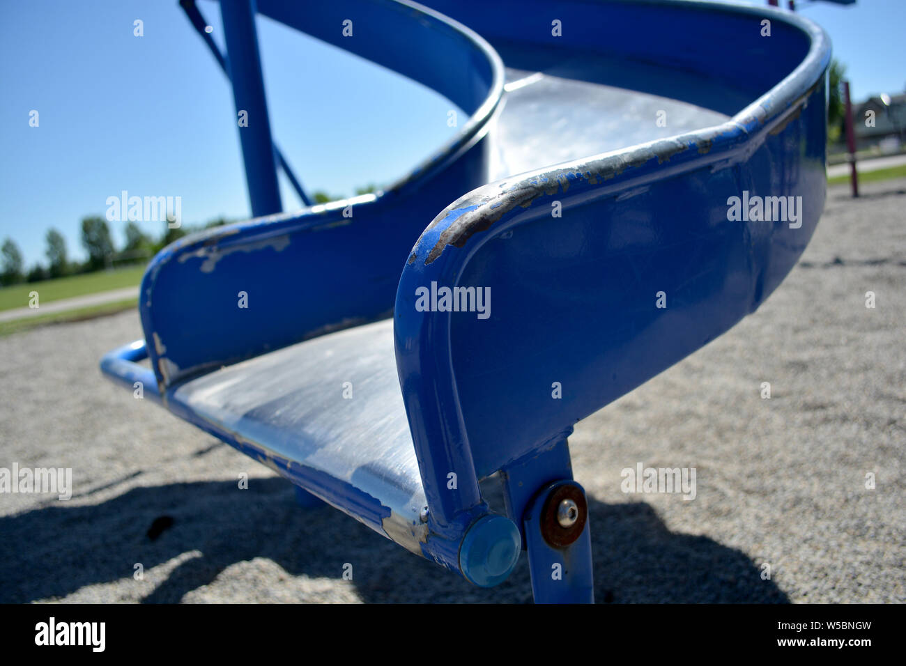 Colourful playground slide in school yard with school in background ...