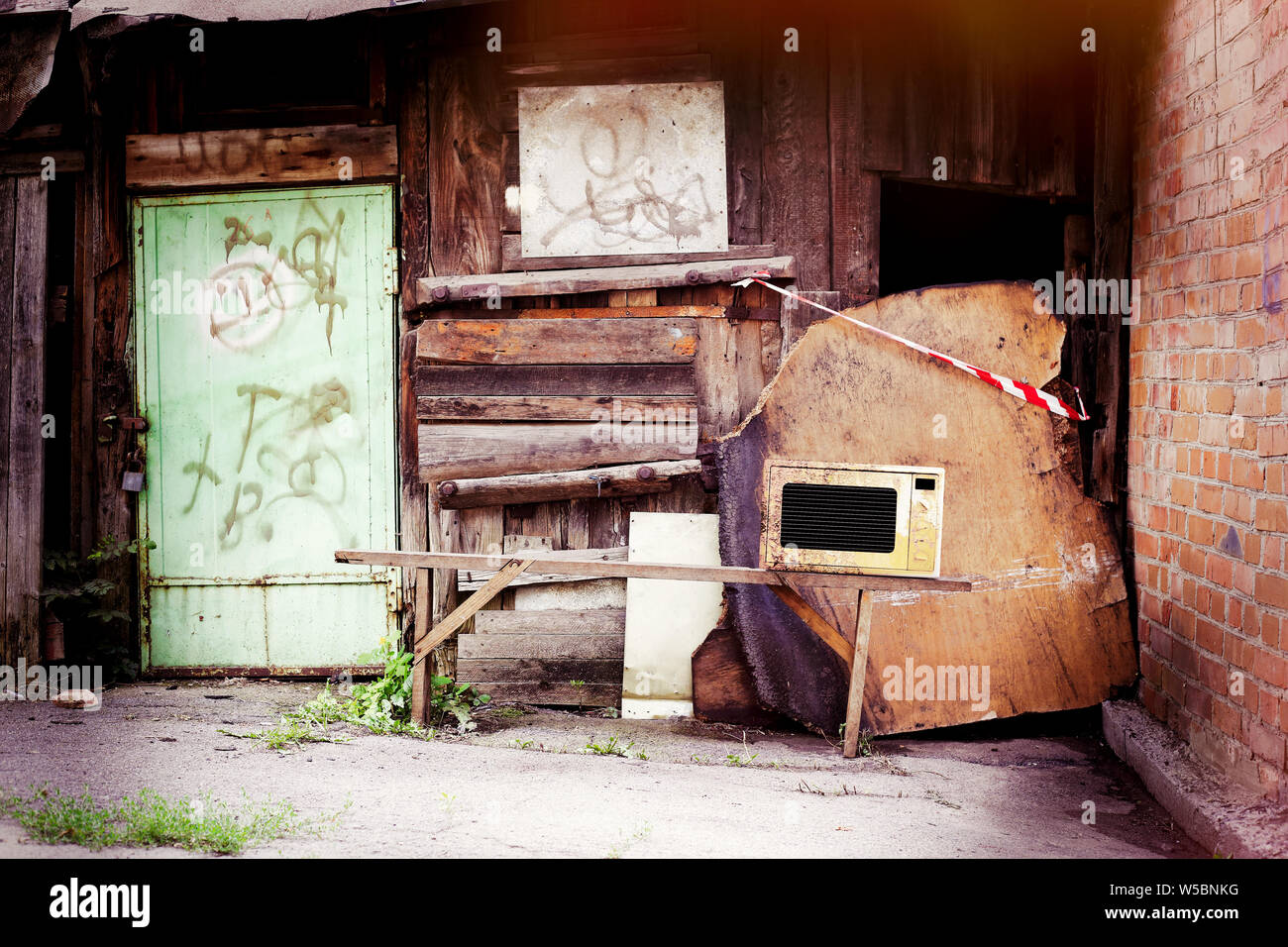 Microwave Oven on a bench against the background of slums ruins of the ...