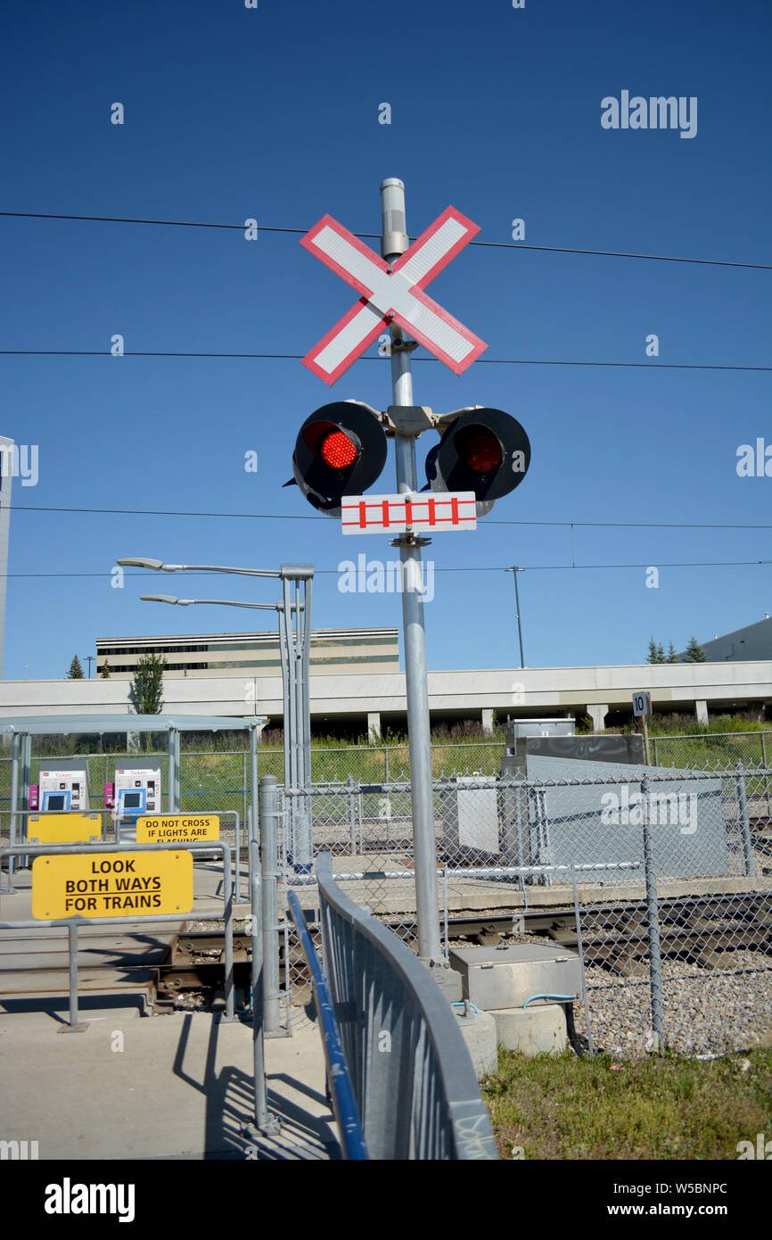 Pedestrian transit train crossing with warning lights Stock Photo - Alamy