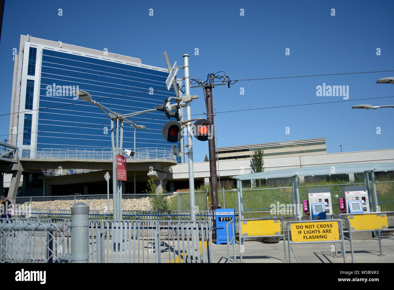 Pedestrian transit train crossing with warning lights Stock Photo - Alamy