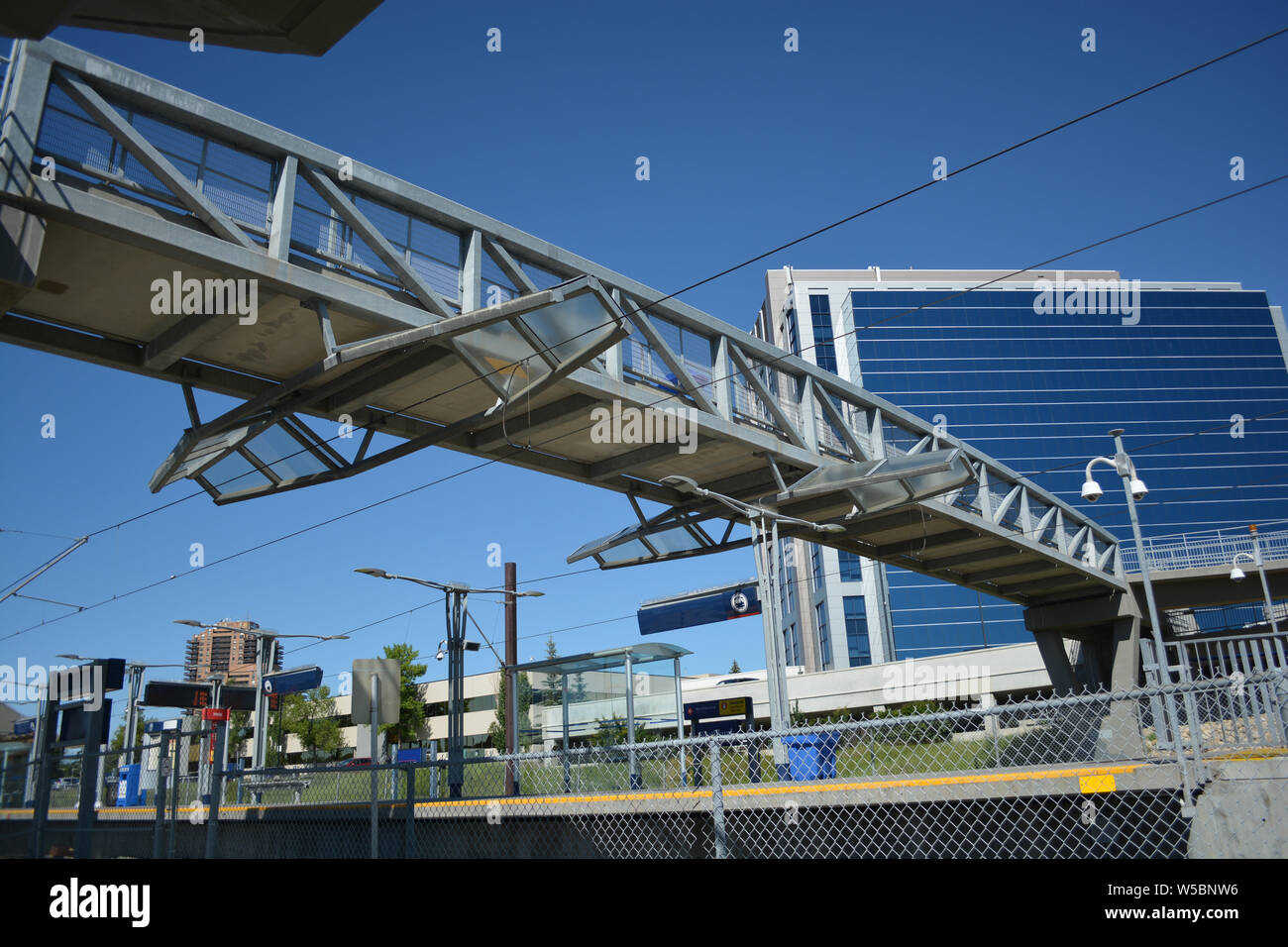 Pedestrian bridge over train track line at city station Stock Photo - Alamy