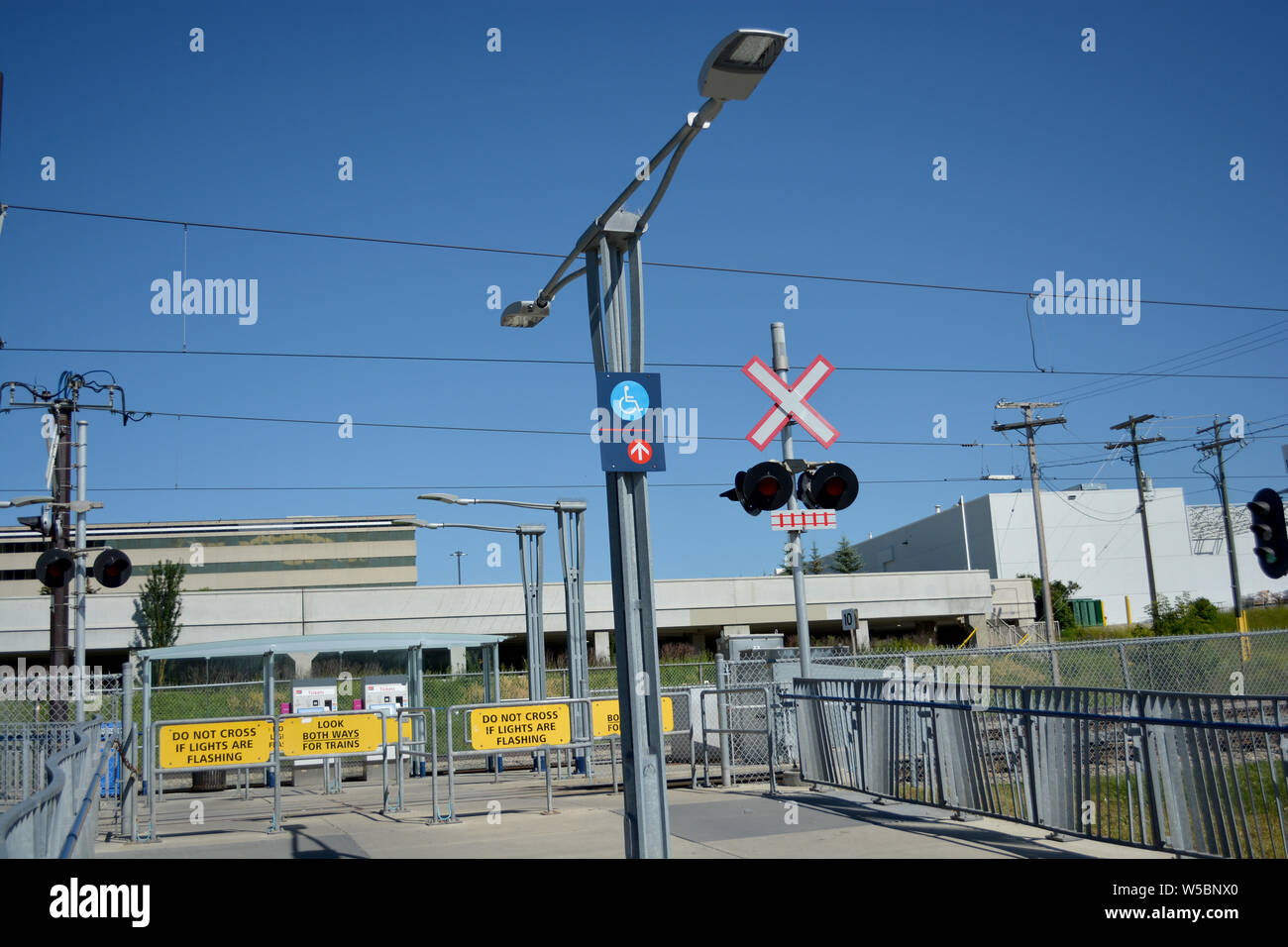 Pedestrian transit train crossing with warning lights Stock Photo - Alamy