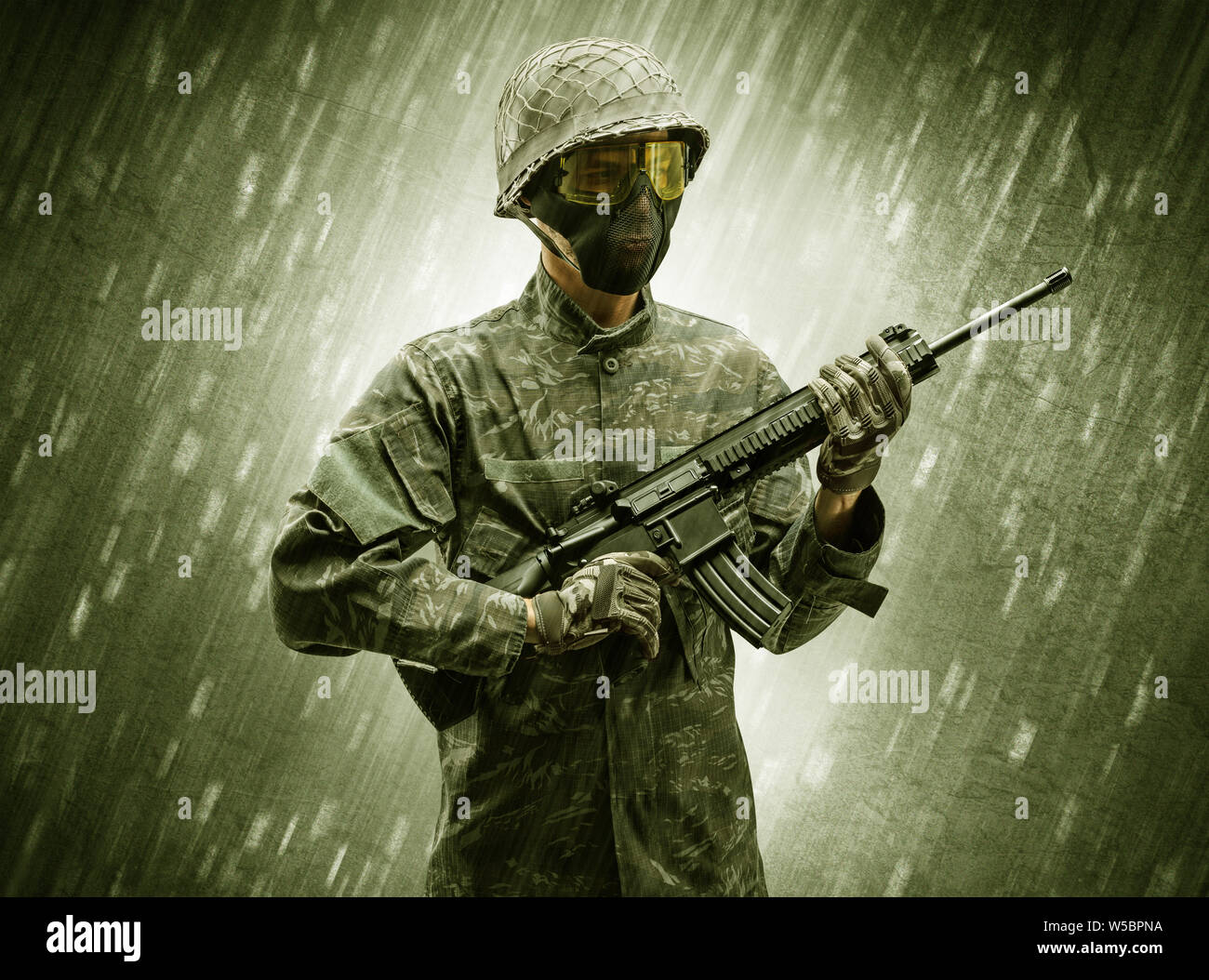 Armed soldier standing in rainy weather Stock Photo - Alamy