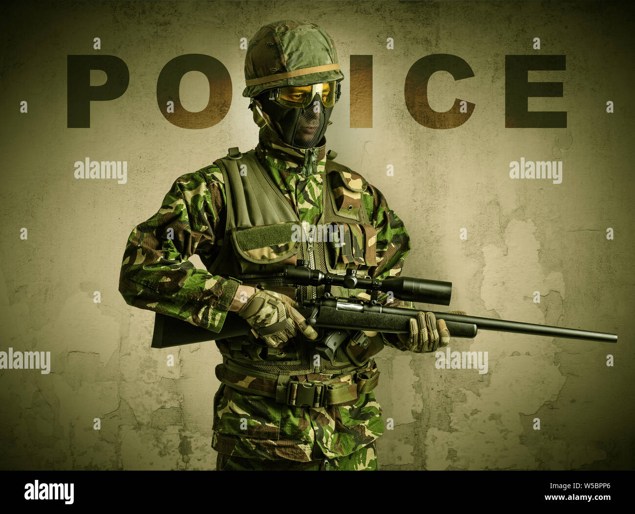 Uniformed armed soldier with damaged wall background Stock Photo - Alamy