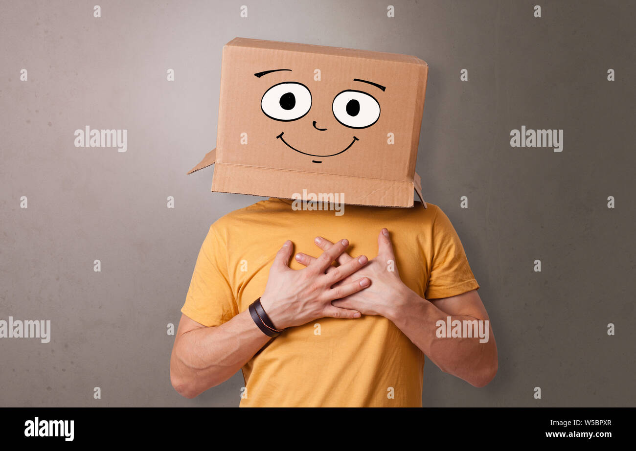 Young boy standing and gesturing with a cardboard box on his head Stock ...