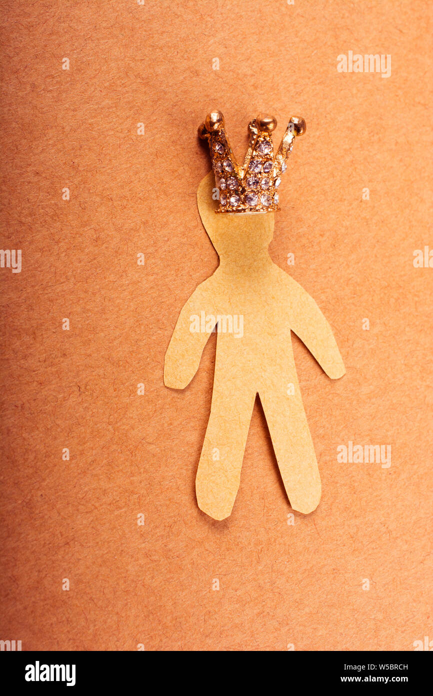 Paper man shape with a crown on it on canvas Stock Photo - Alamy