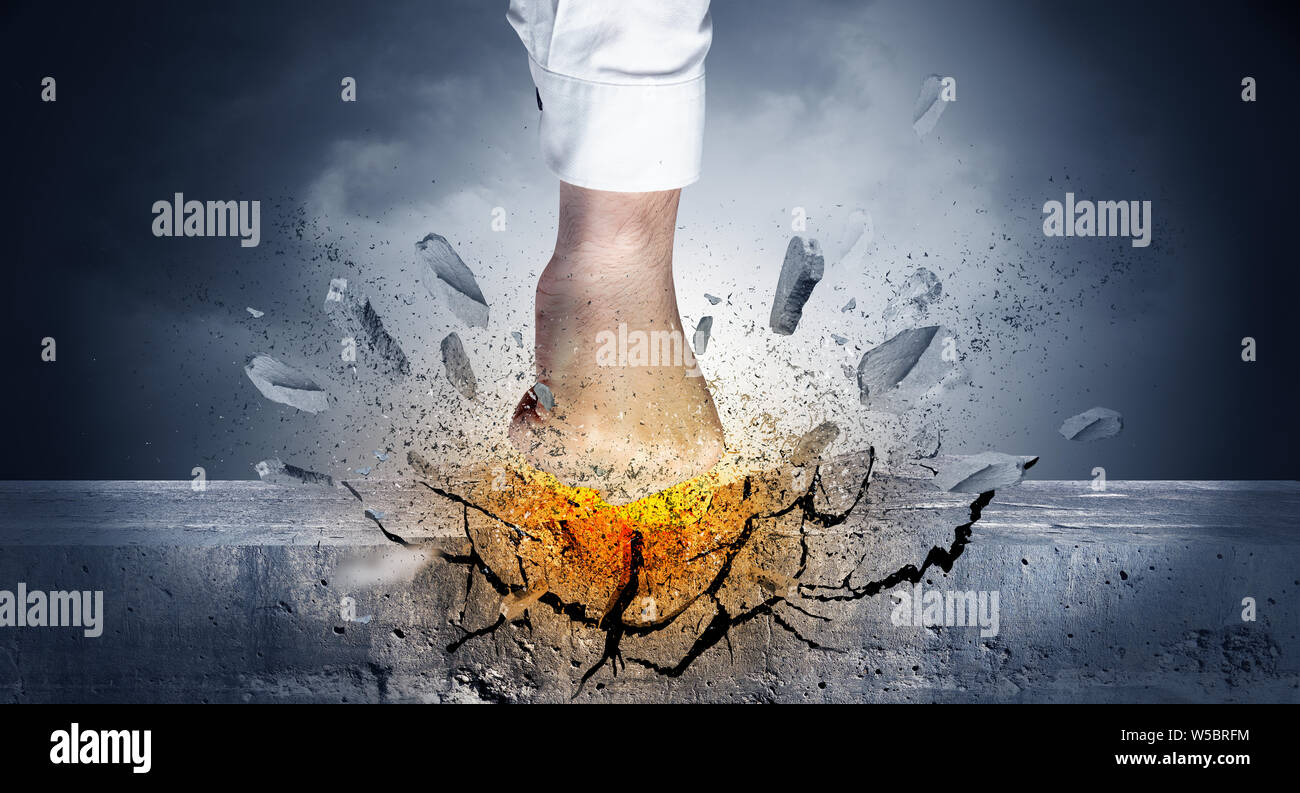 Big hand hits intense and breaks a crass stonewall Stock Photo - Alamy