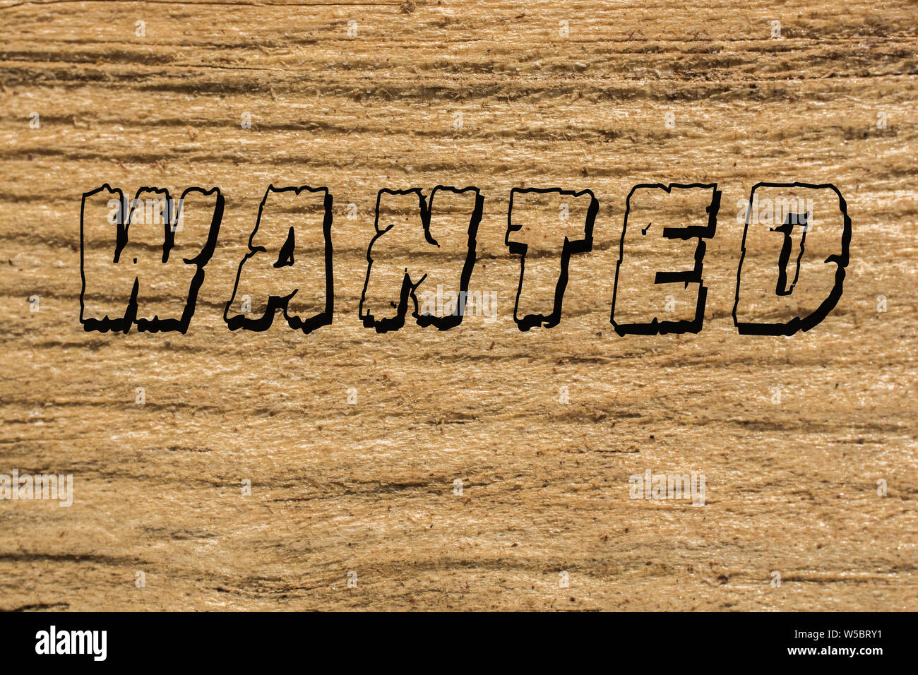 WANTED written on wood with texture patterns Stock Photo - Alamy
