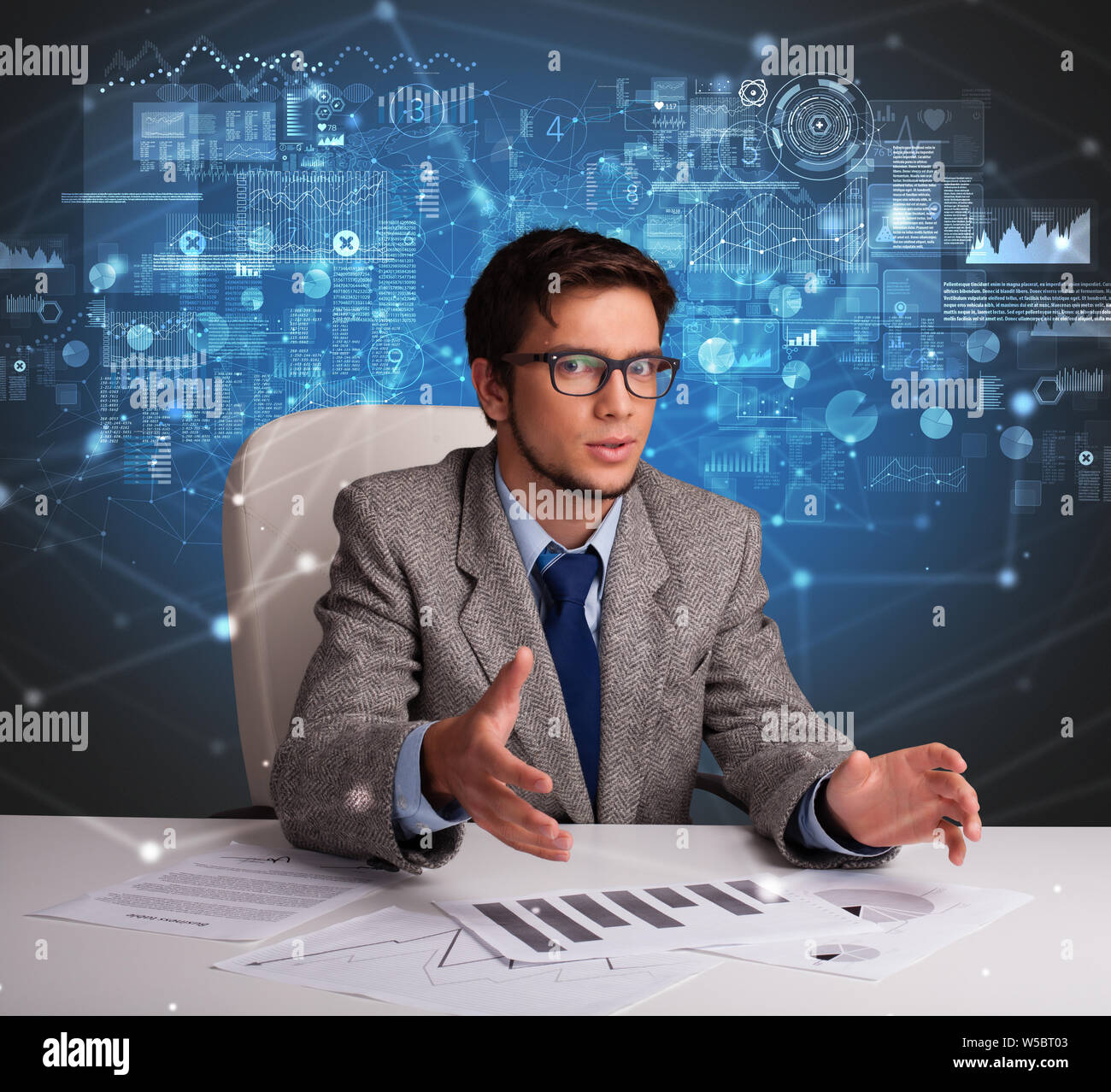 Young manager at the office making report and statistics Stock Photo ...