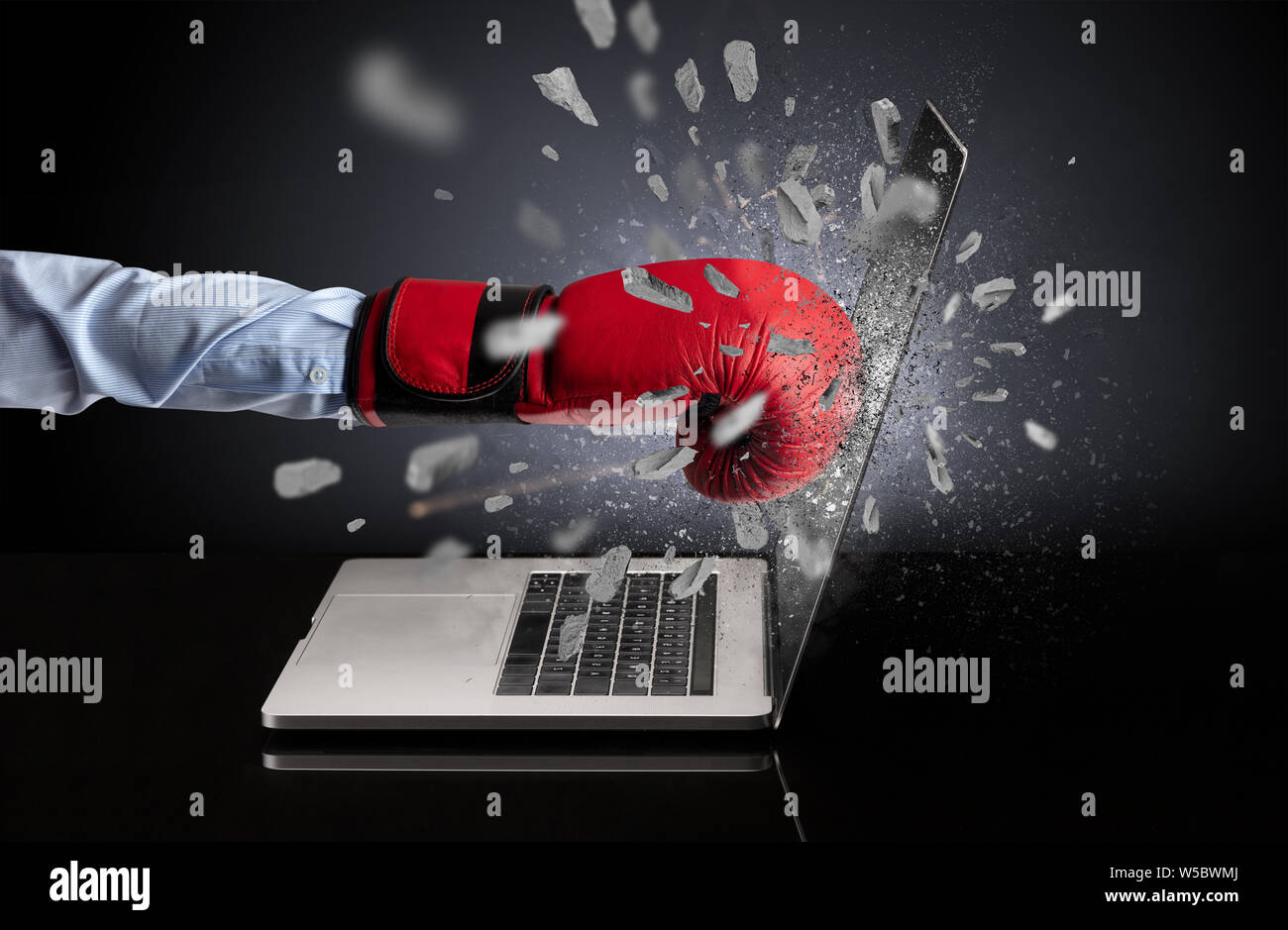 Strong male hand breaks laptop screen Stock Photo - Alamy