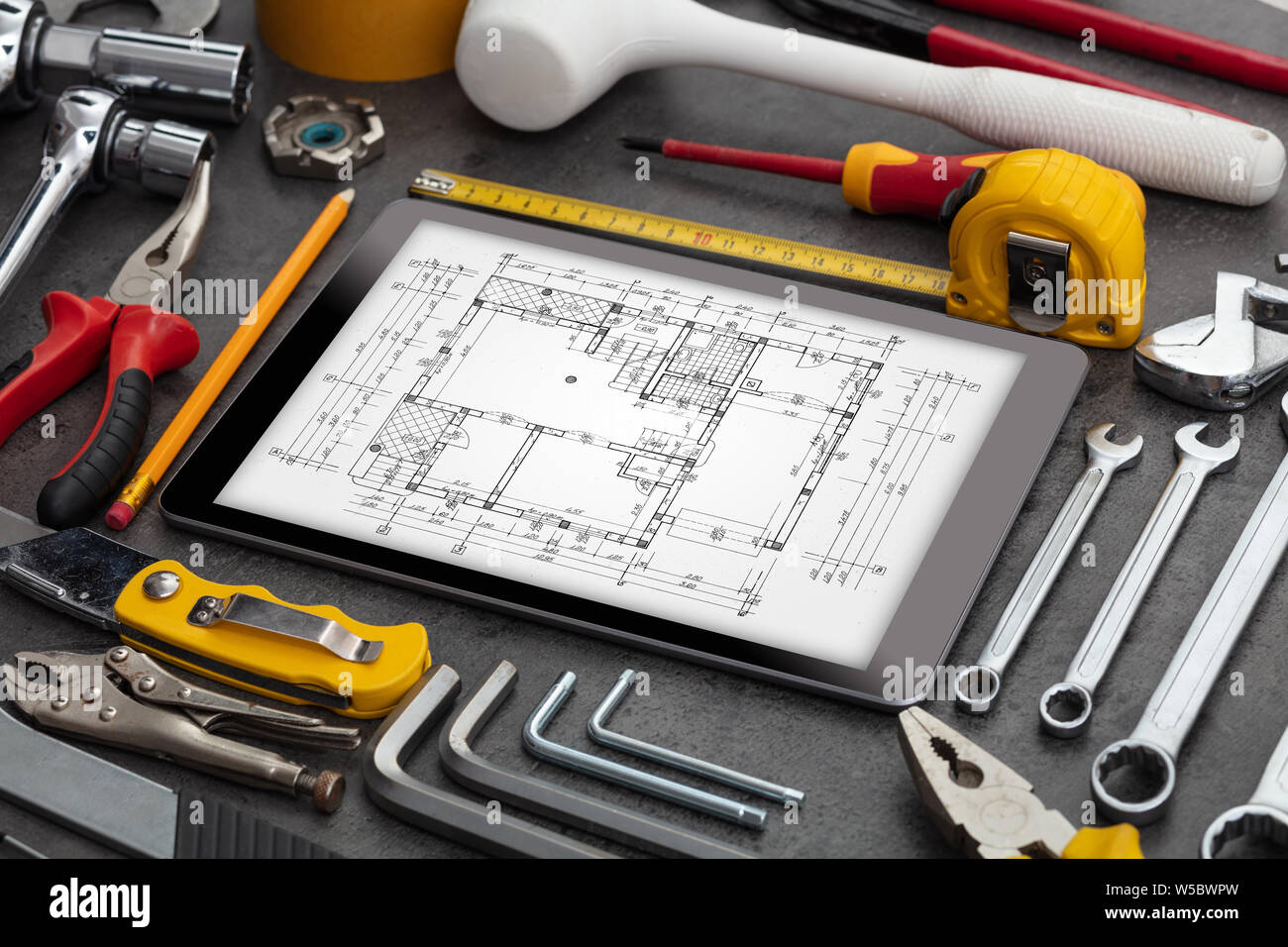 Tablet with construction tools and blueprint concept Stock Photo - Alamy