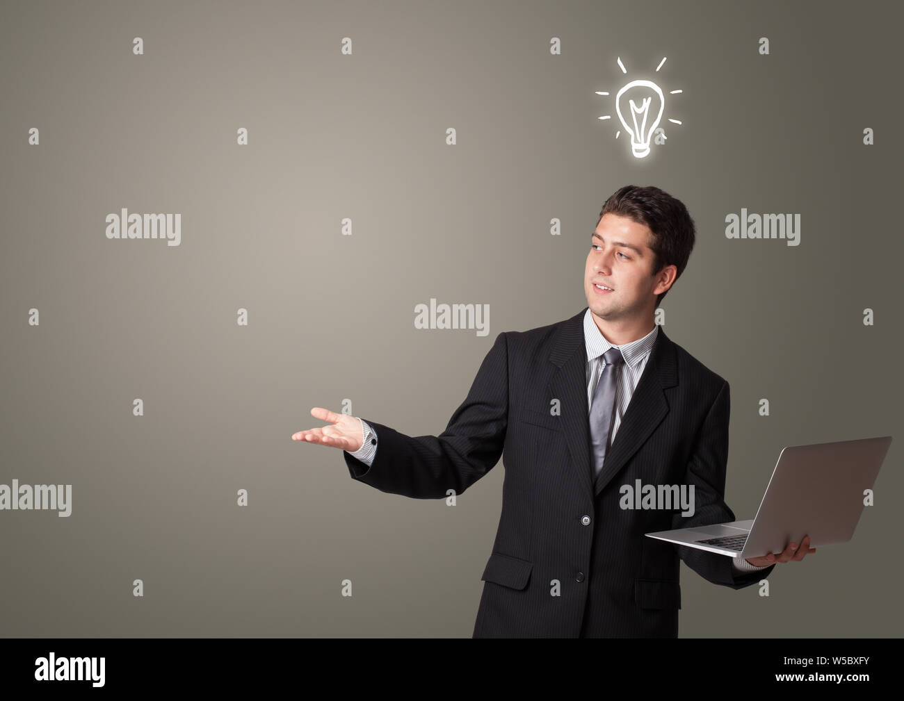 Young smiling person presenting new idea concept Stock Photo - Alamy
