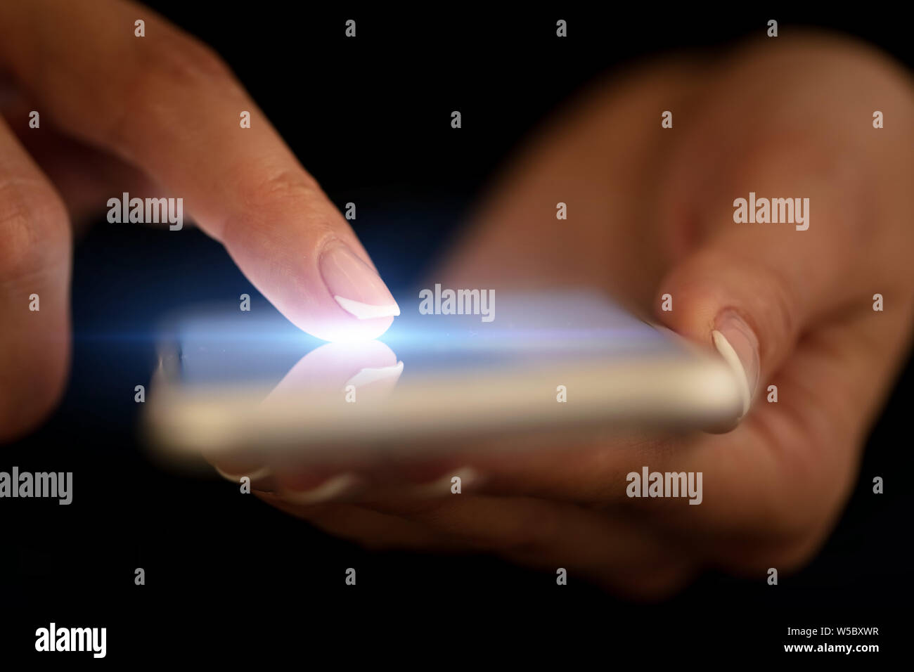 Finger touching phone with dark background with copyspace Stock Photo ...