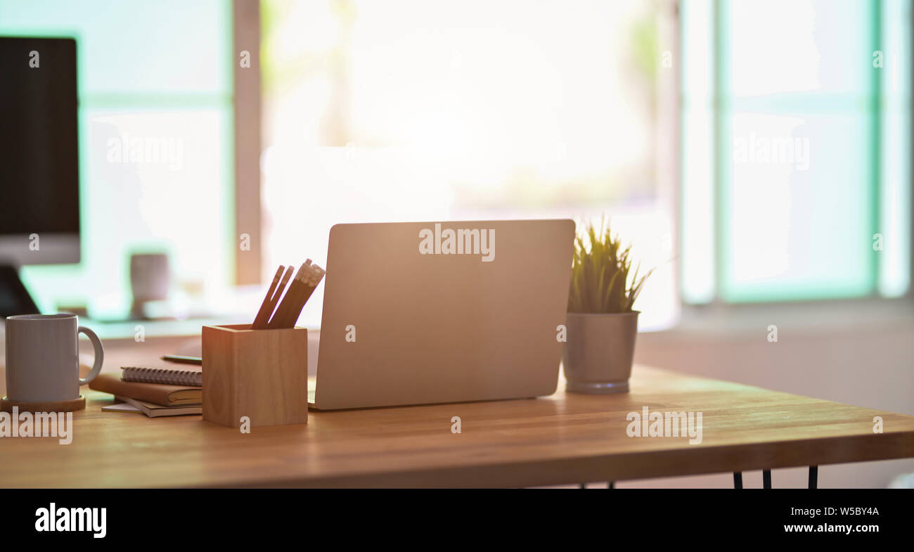 Freelancer's work space with laptop computer, office supplies and ...