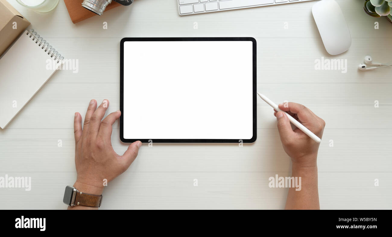 Close-up view of photographer's hands editing images on blank screen ...