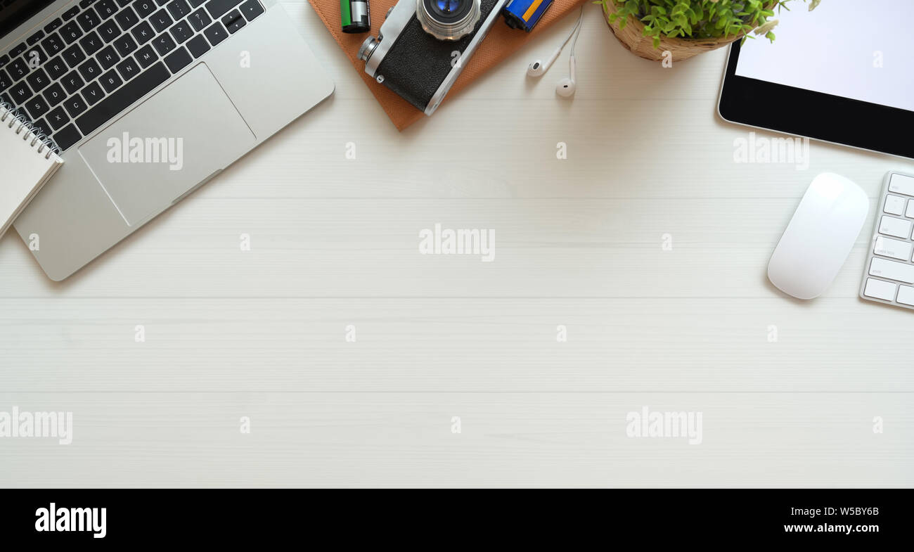 Professional photographer's desk with laptop computer, office supplies ...