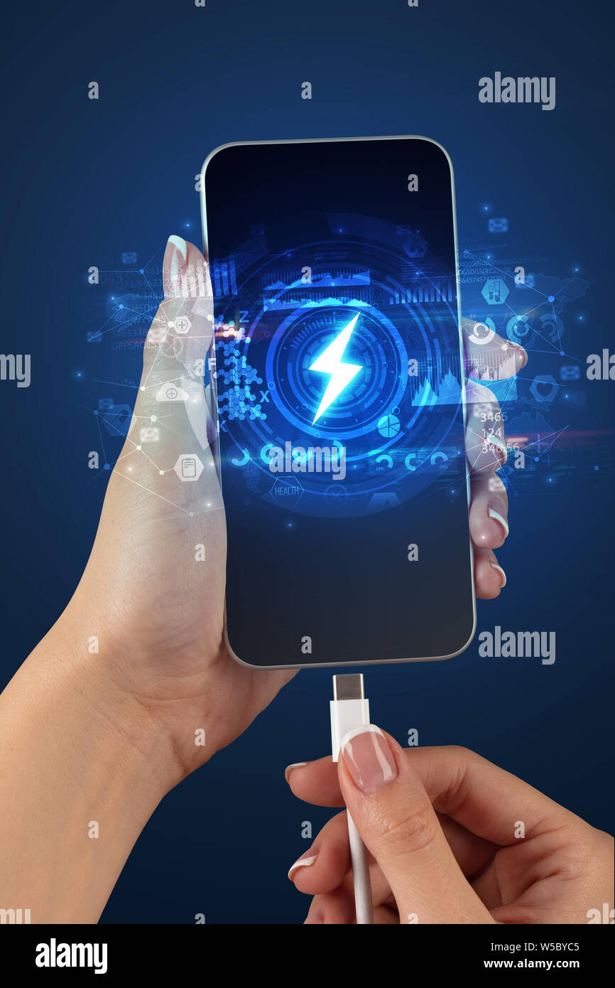 Elegant hand charging smartphone with global report concept Stock Photo ...