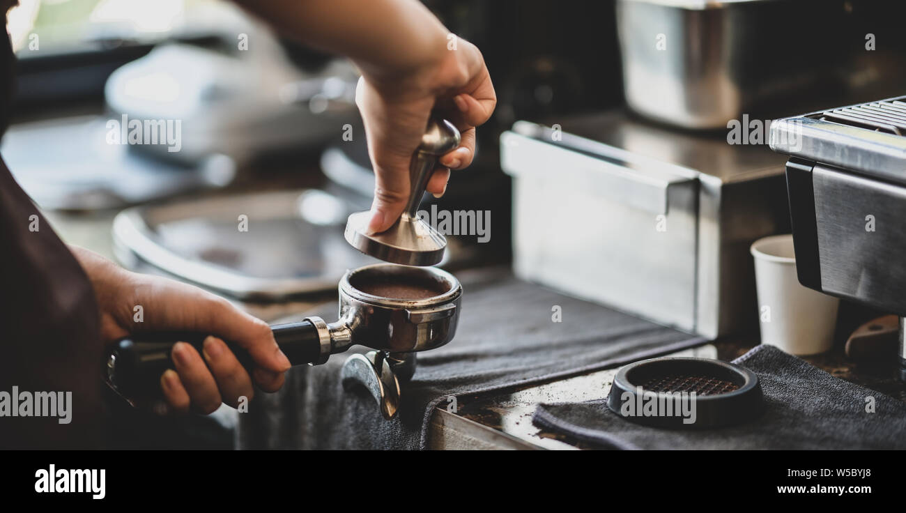Close-up view of female barista hand's grinding coffee with grinder machine in cafe Stock Photo ...