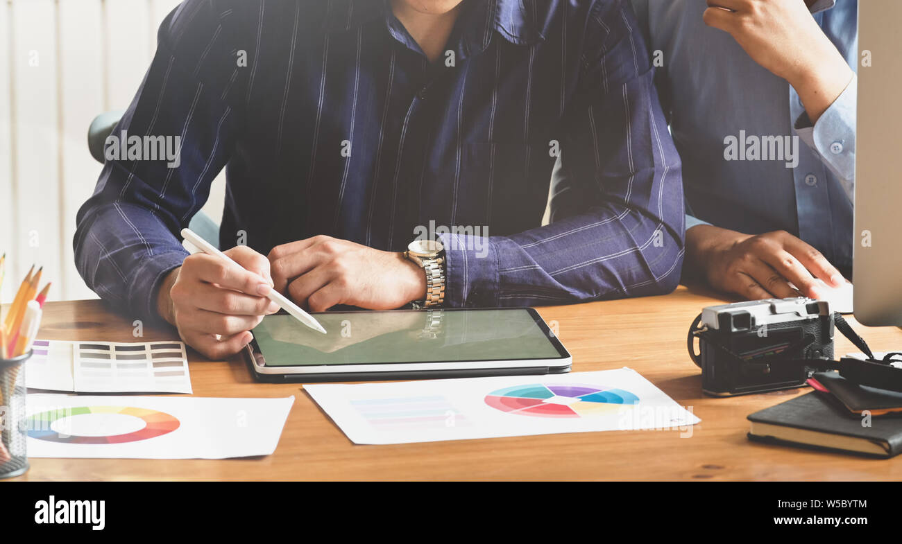 Graphic designer and photographer working on project together in ...