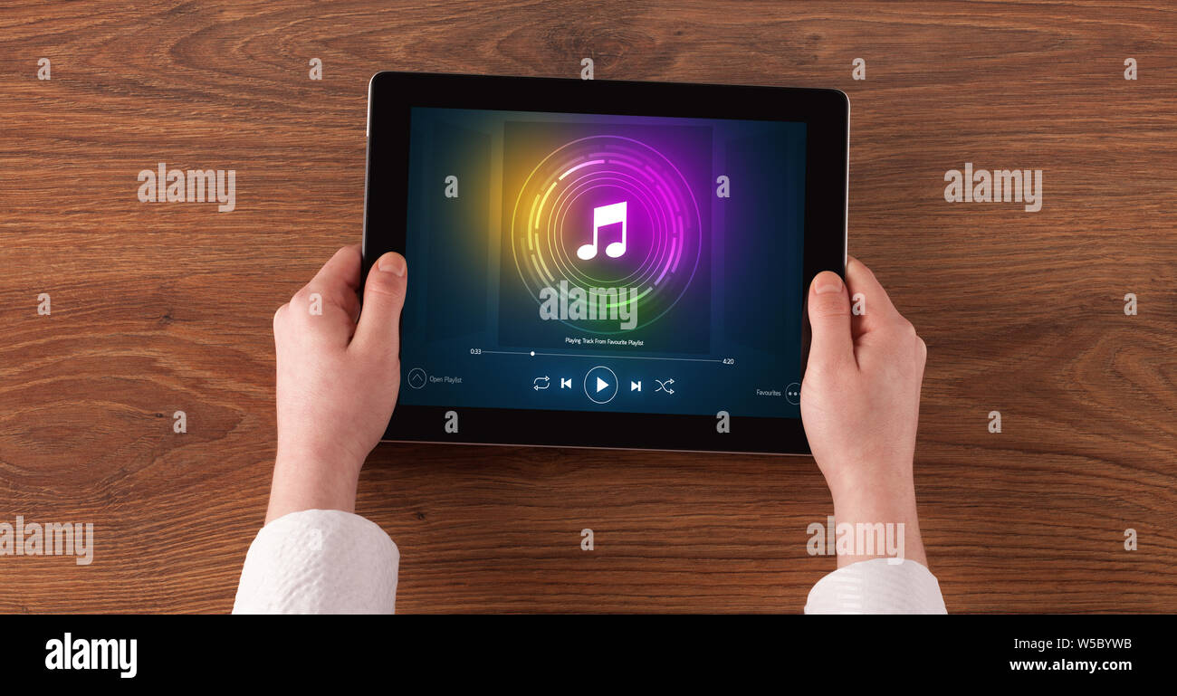 Hand touching tablet with music play concept Stock Photo - Alamy