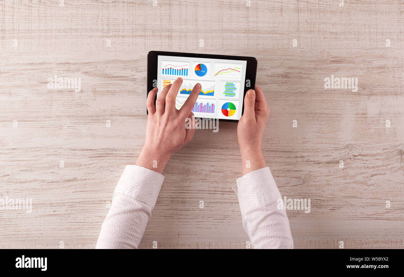 Hand making diagrams and charts on tablet Stock Photo - Alamy