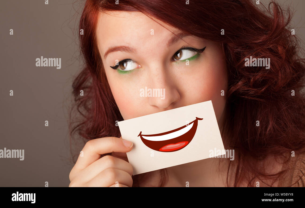 Person holding card in front of his mouth with ironic smile Stock Photo ...