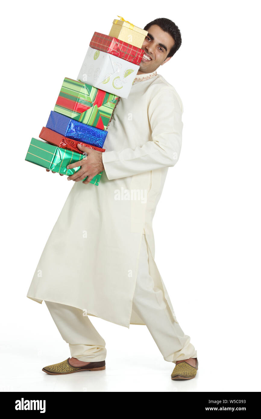 Man carrying gift boxes and smiling Stock Photo - Alamy