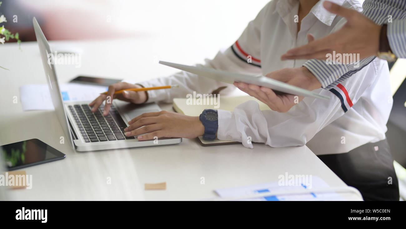UI UX website development team sketching wireframe layout for responsive web content in studio ...