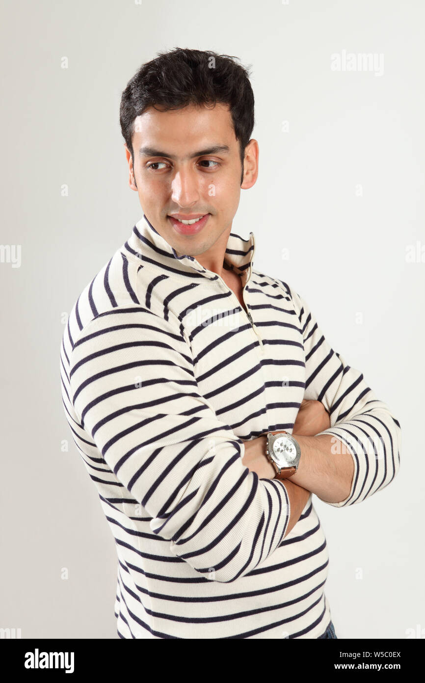 Man smiling with his arms crossed Stock Photo - Alamy