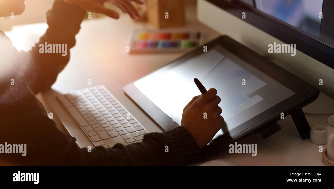 Female creative designer using a graphic tablet screen and stylus ...