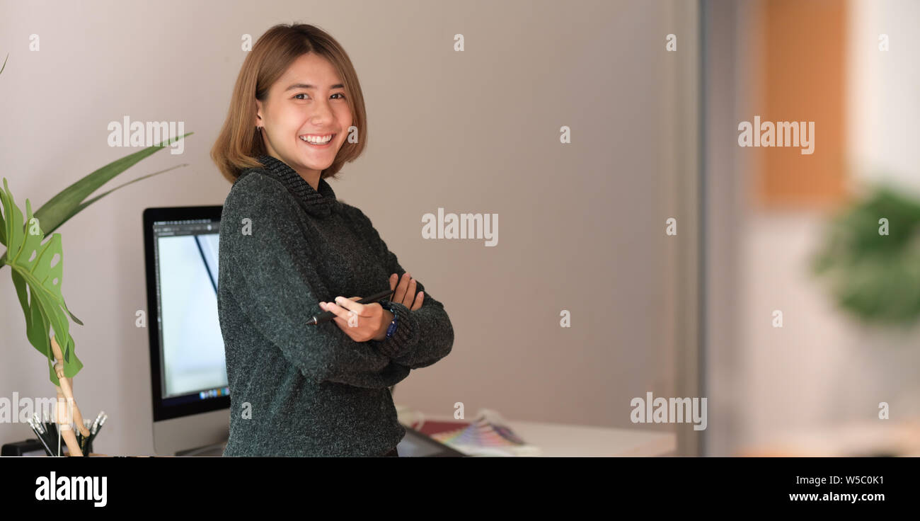 Confident Asian female freelancer at her workspace desk Stock Photo - Alamy