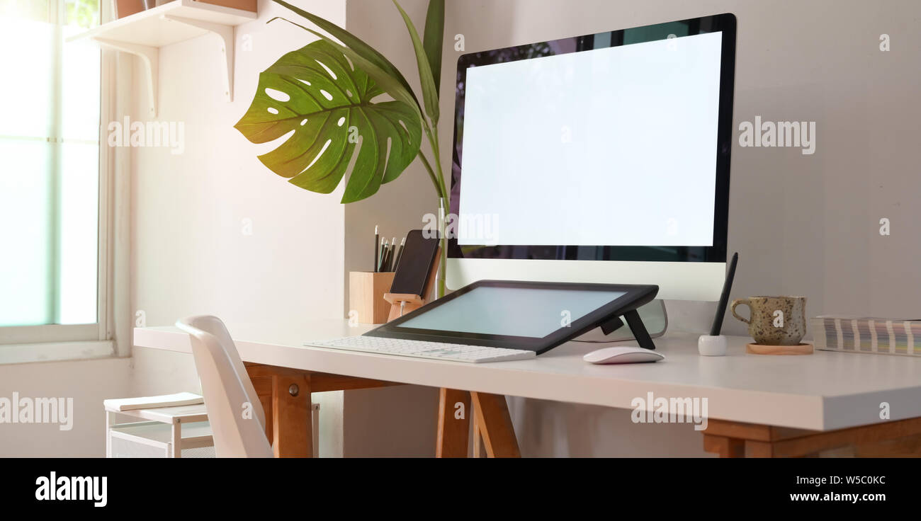 Creative designer workspace with blank screen on white desk Stock Photo ...