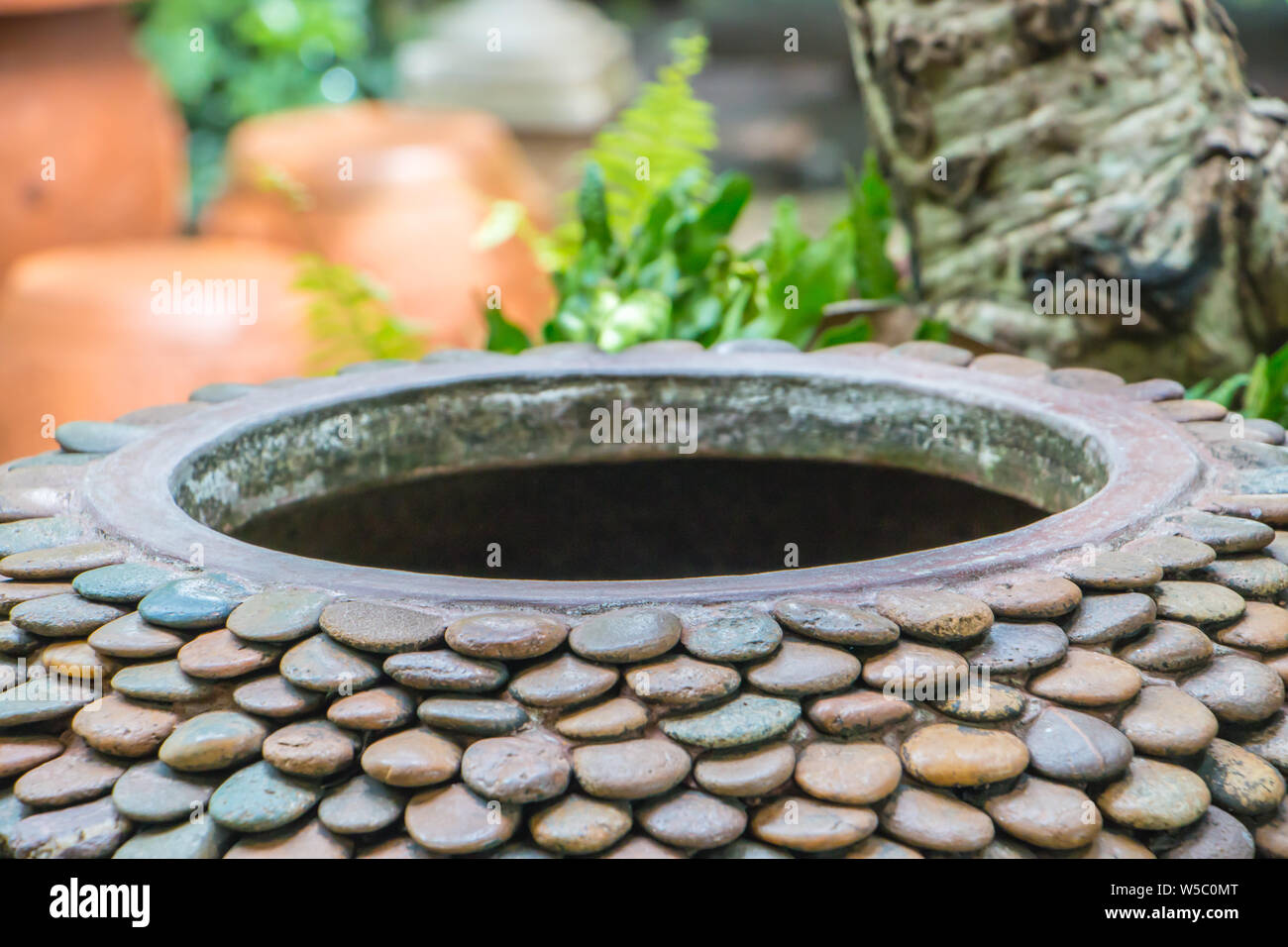 Gigantic jar, Warer jar with stone pattern in the garden Stock Photo ...