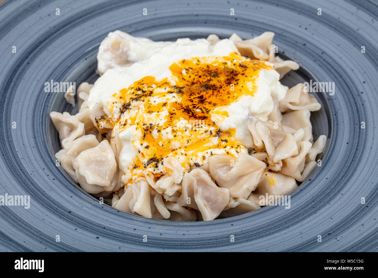homemade delicious turkish manti ( turkish ravioli ) with yogurt and ...