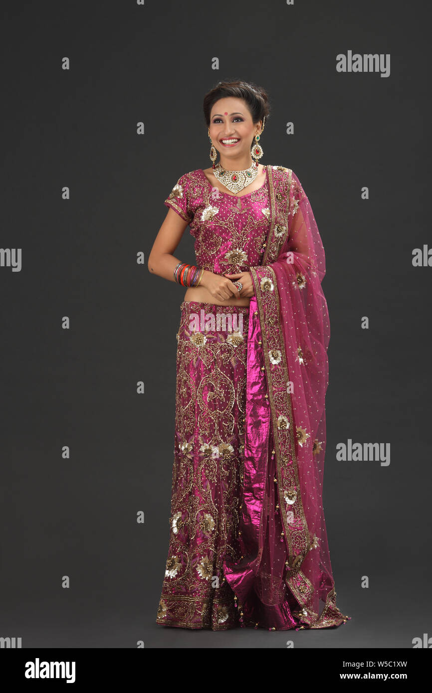 Indian bride standing and smiling Stock Photo - Alamy