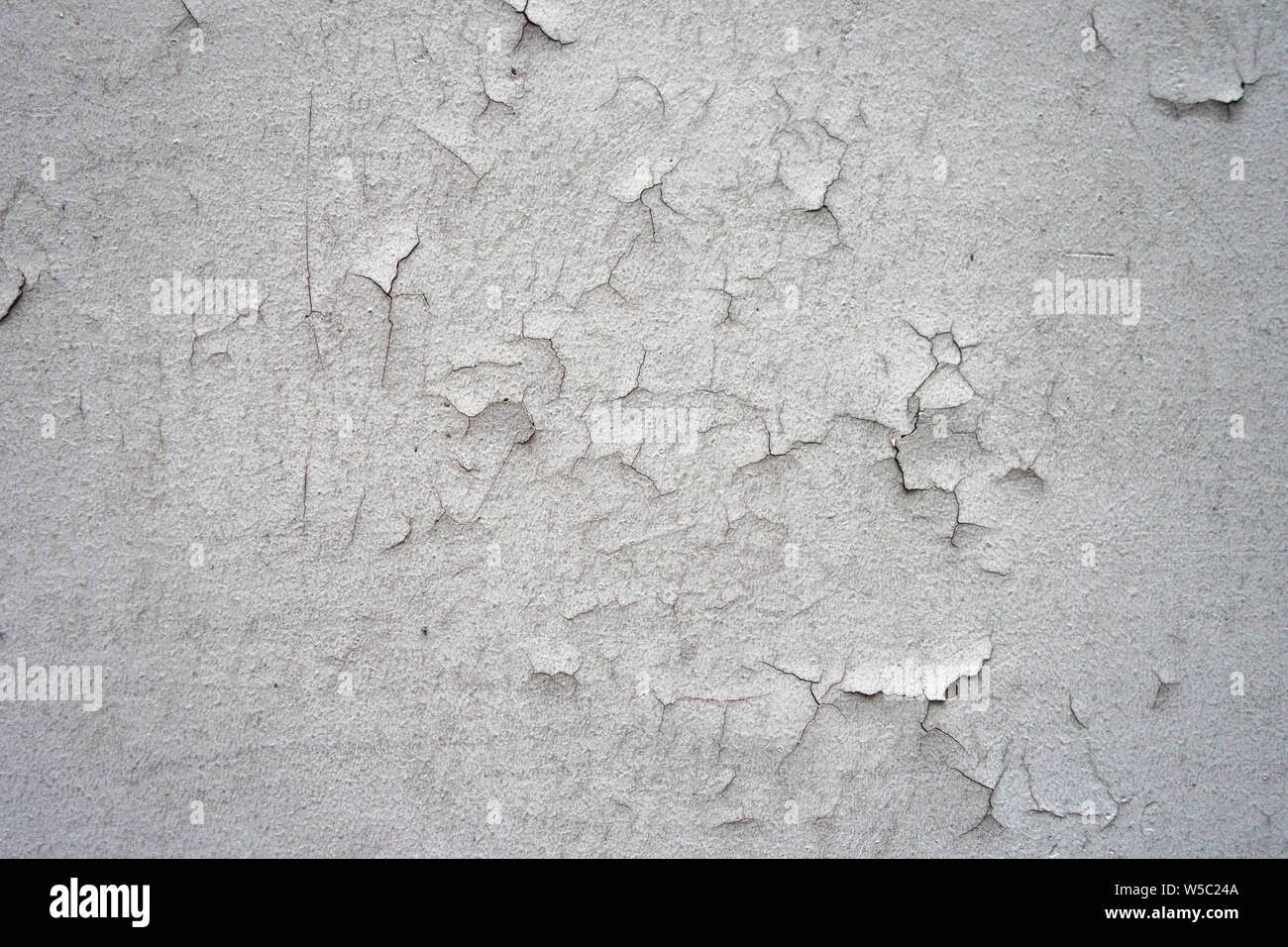 cracking paint on a white wall surface background Stock Photo - Alamy
