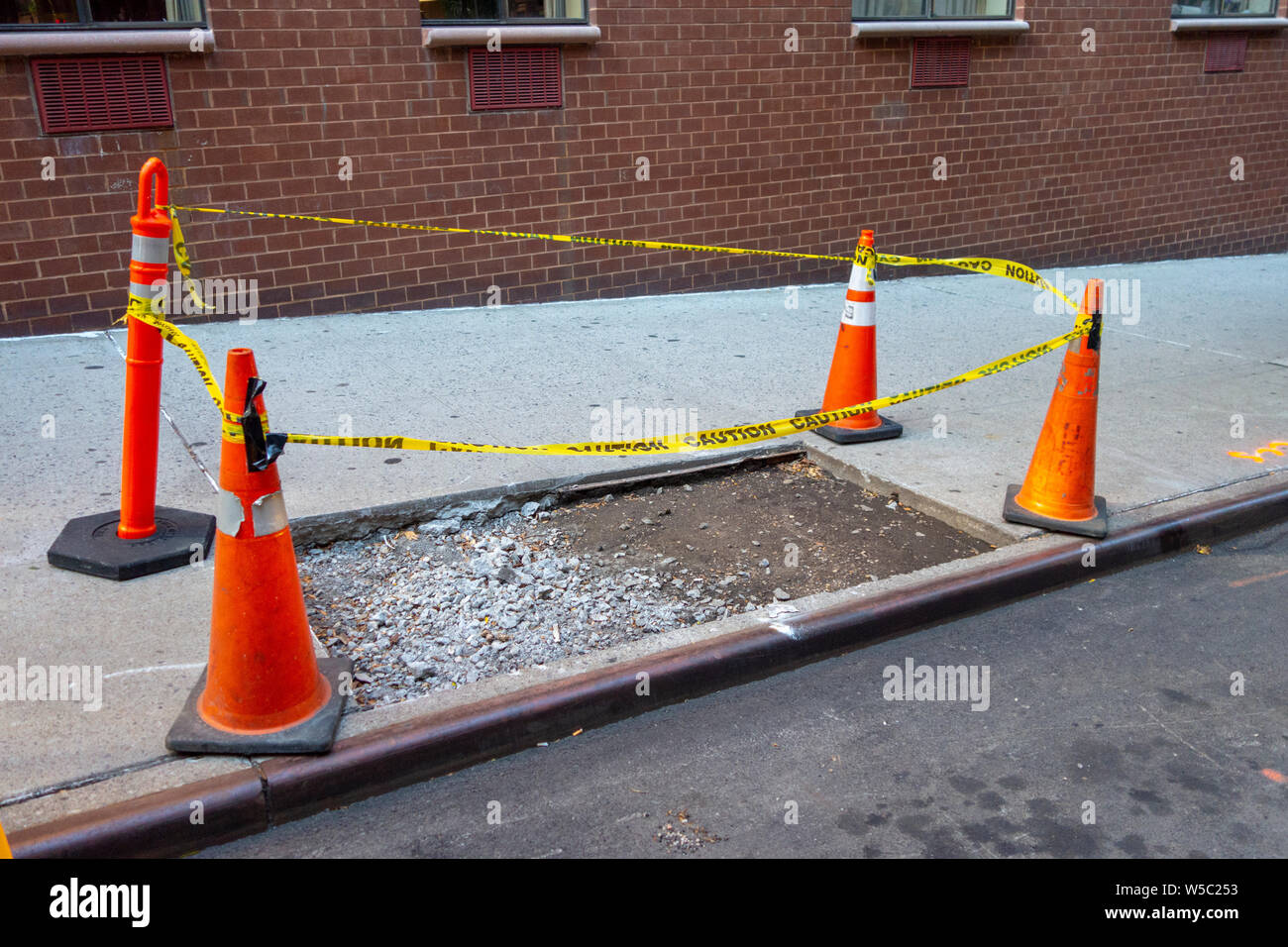 damaged walkway with red orange white cones and cone connected with ...