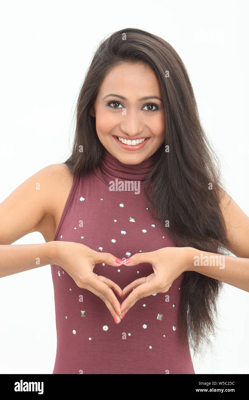 Woman making heart shape with her hands and smiling Stock Photo - Alamy