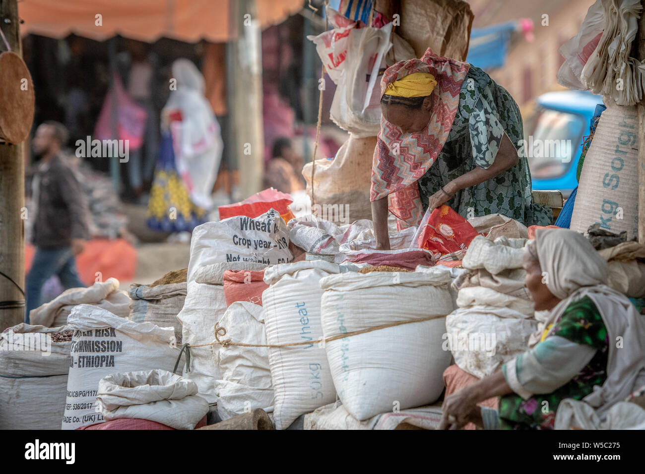 Women unpacking produce delivered to the market places of Mekele ...