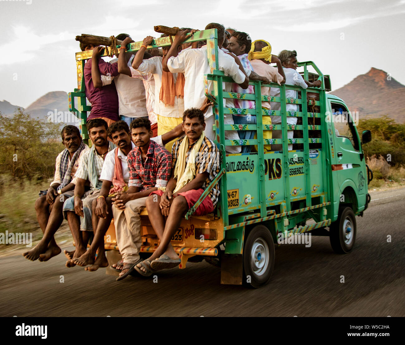Kochi, India, Mar 4, 2018, Men ride in truck - Men crowd into the back ...