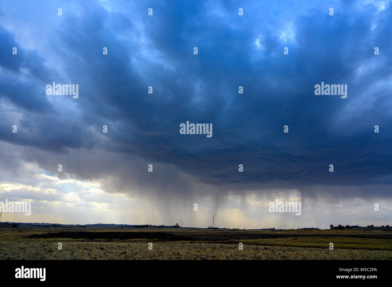 Stormy skies begin to pour rain over fields in Debre Berhan, Ethiopia ...